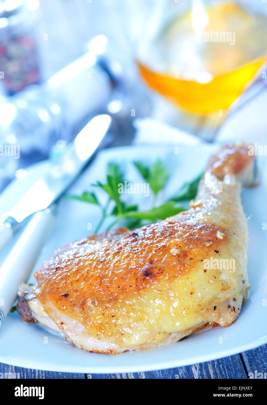 fried chicken leg on plate and on a table Stock Photo - Alamy