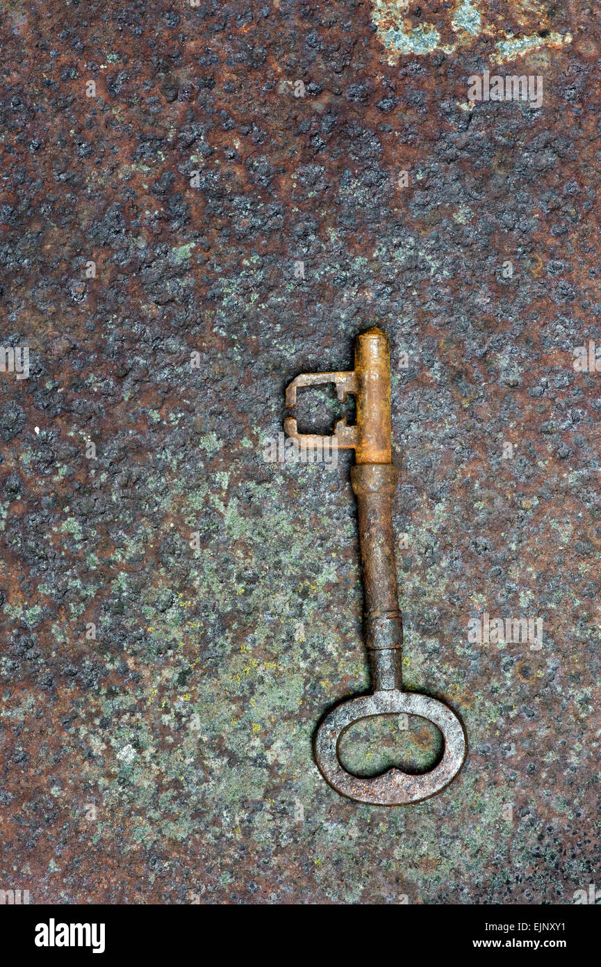 Old key on a rusty metal texture background Stock Photo - Alamy