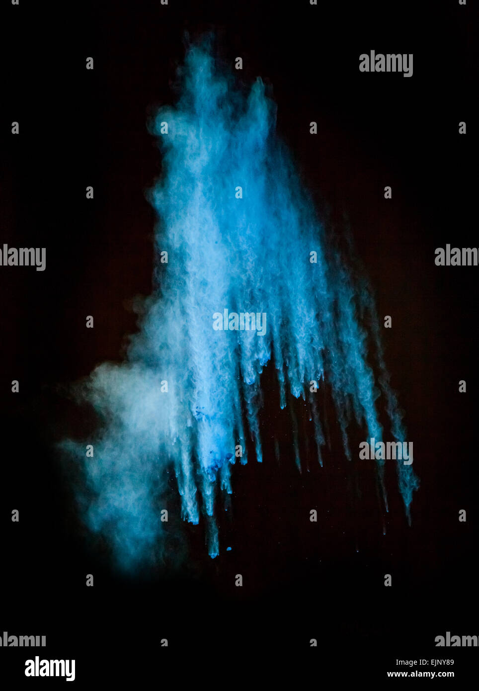 Freeze motion of blue dust explosion isolated on black background Stock ...