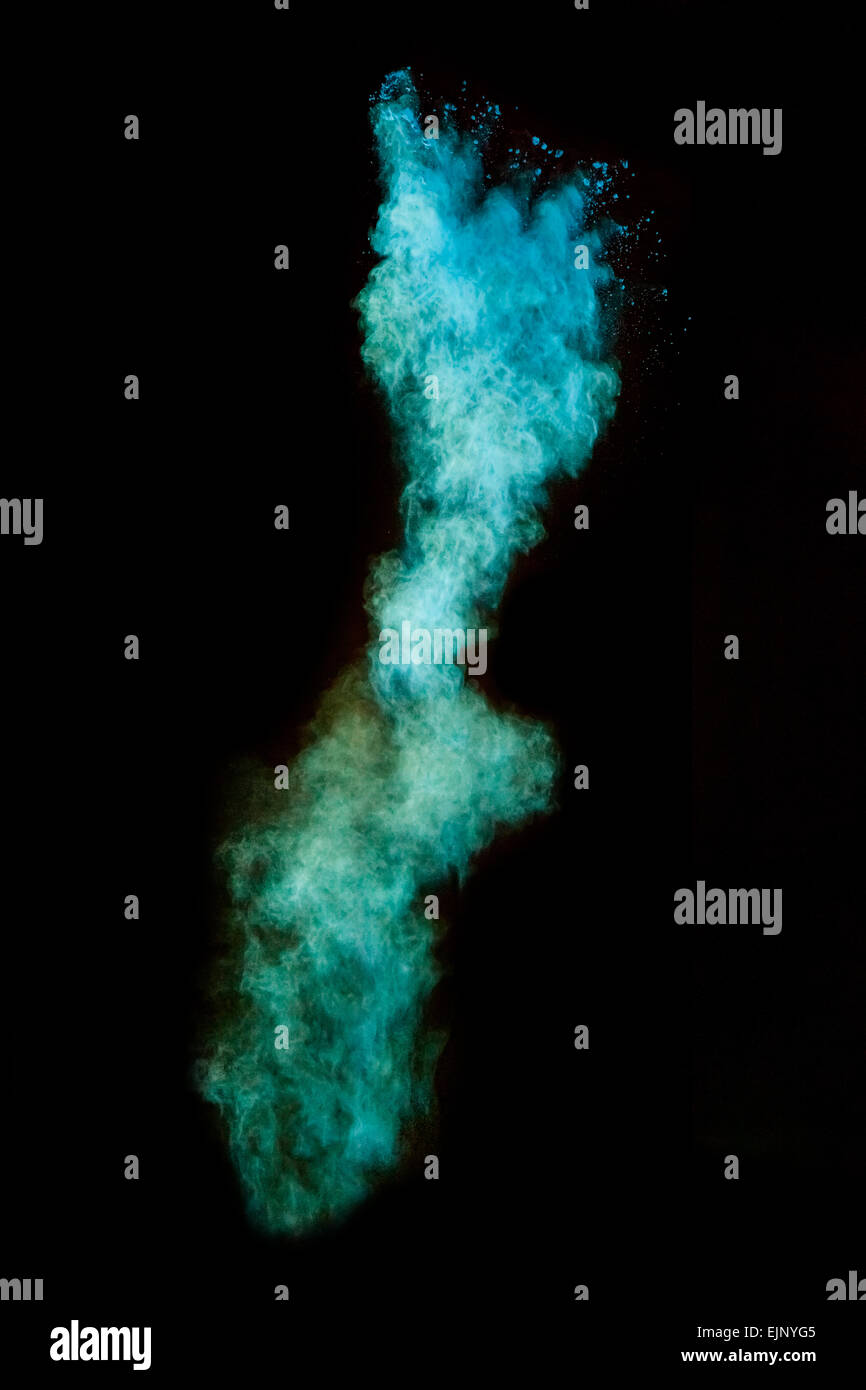 Freeze motion of blue dust explosion isolated on black background Stock ...