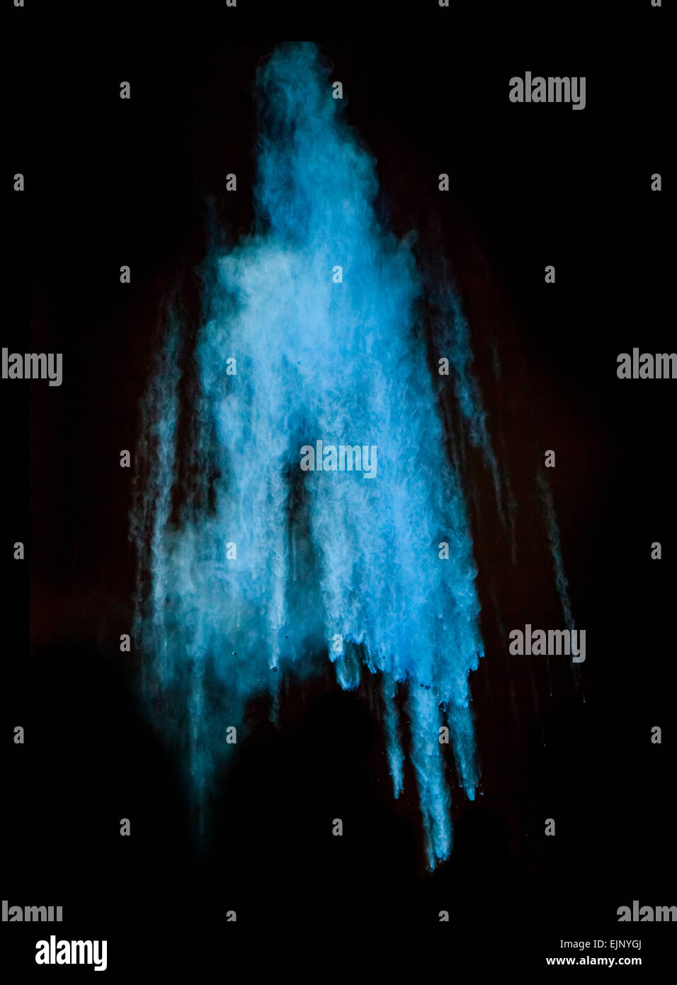 Freeze motion of blue dust explosion isolated on black background Stock ...