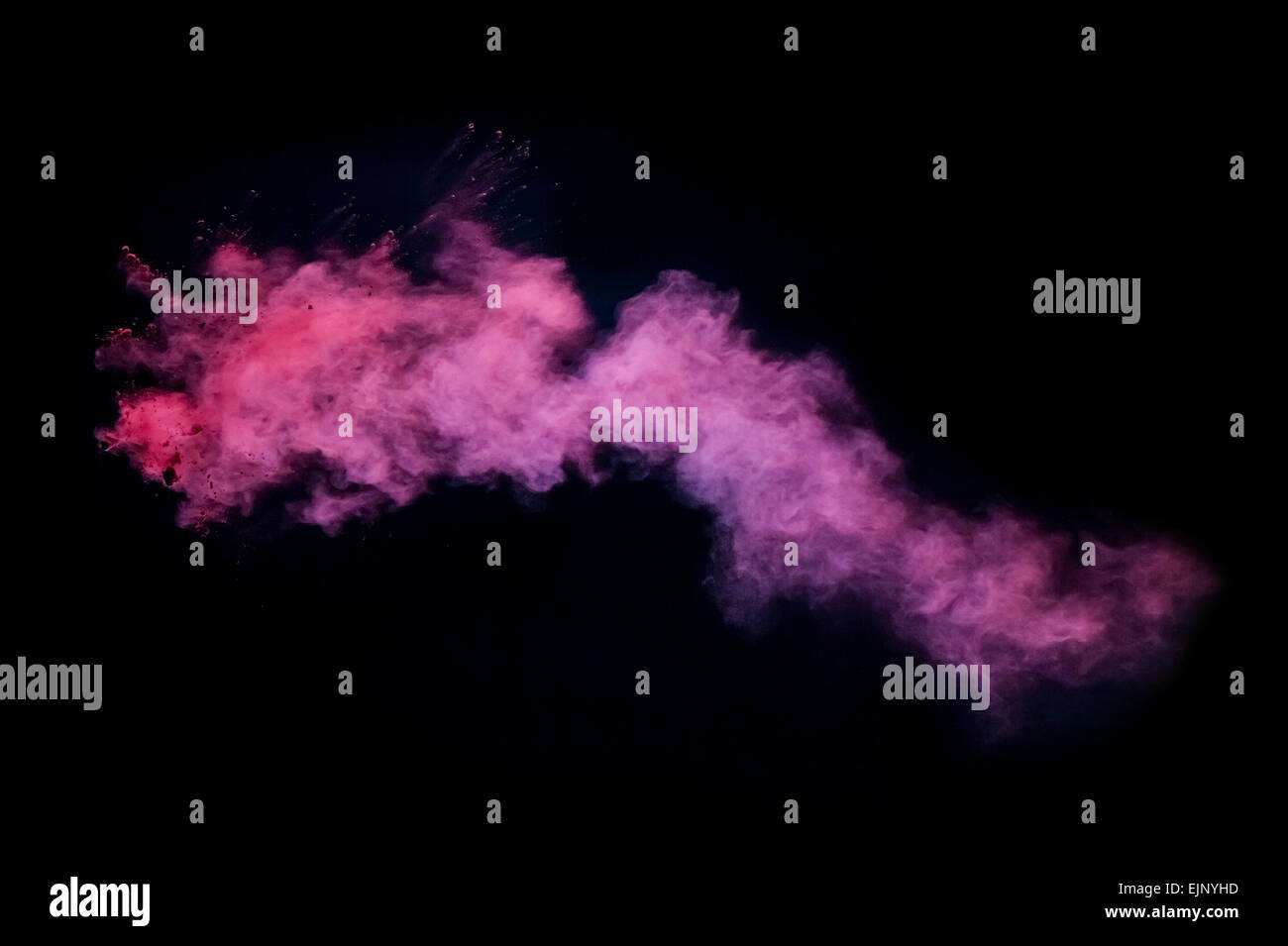 Freeze motion of pink dust explosion isolated on black background Stock ...