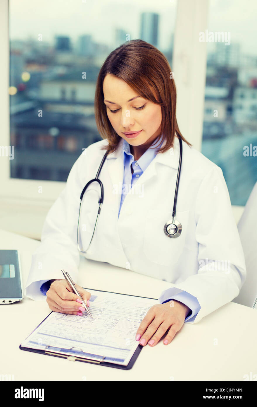 busy doctor with laptop computer and clipboard Stock Photo - Alamy