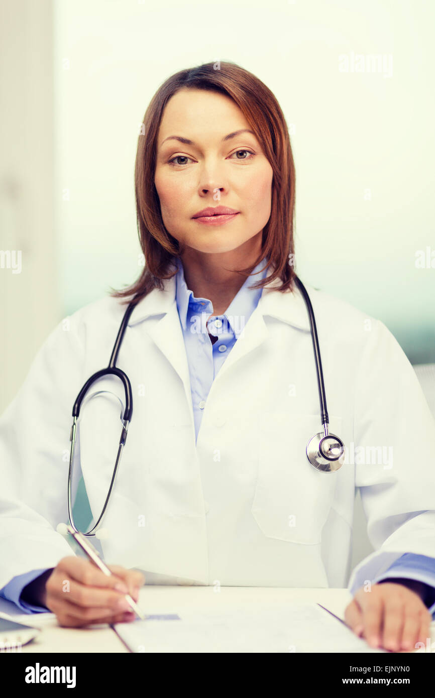 busy doctor with laptop computer and clipboard Stock Photo - Alamy
