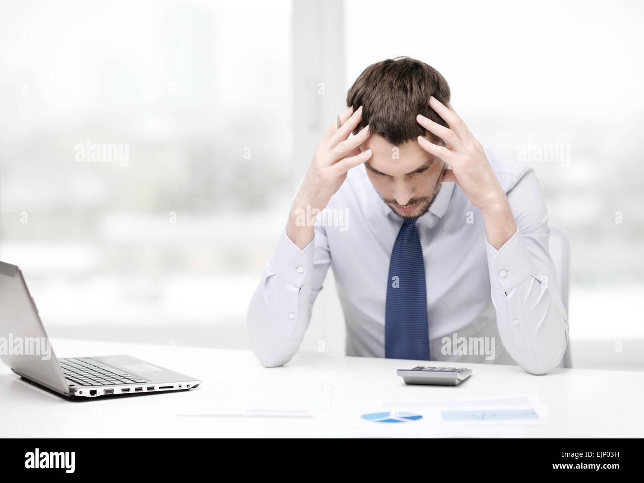 stressed businessman with laptop and documents Stock Photo - Alamy