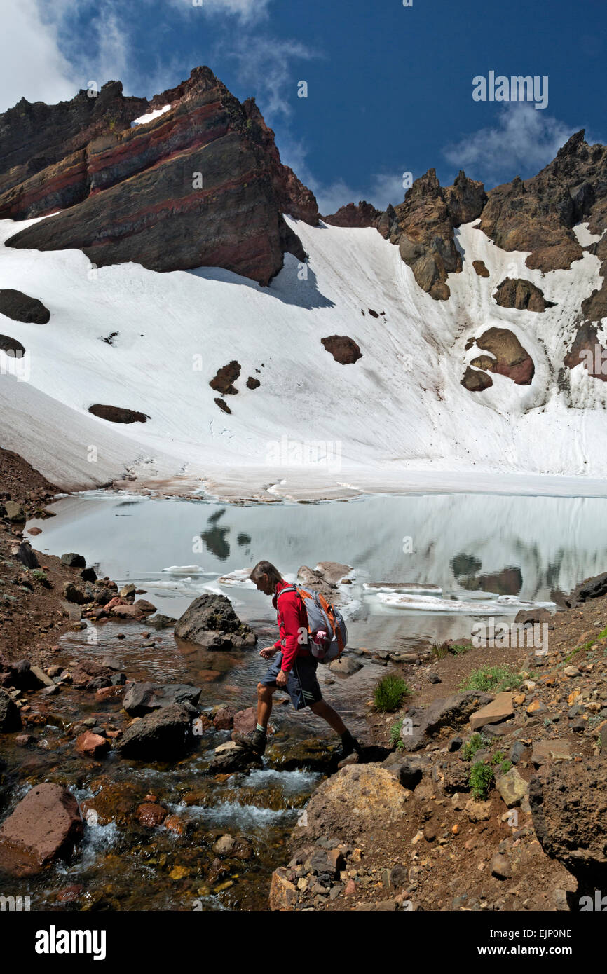 OREGON - Hiker at Crater Lake below summit of Broken Top in Three ...