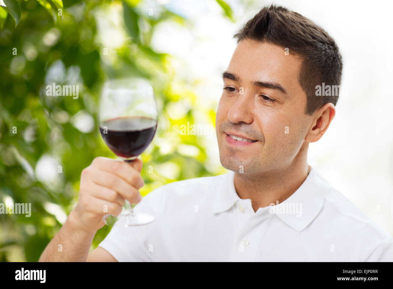 happy man drinking red wine from glass Stock Photo - Alamy