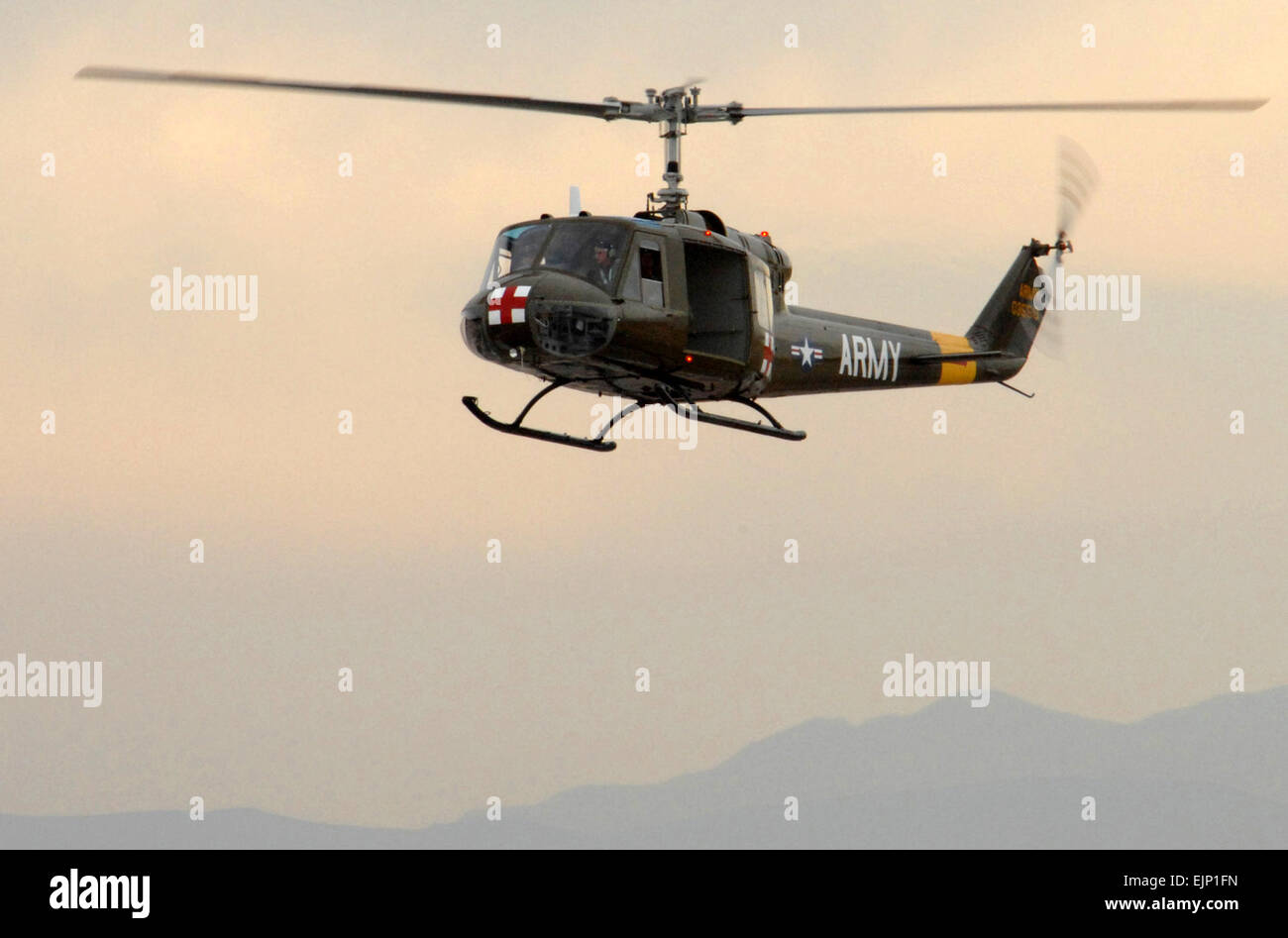 An UH-1 Huey helicopter prepares to land to pick up a downed pilot ...