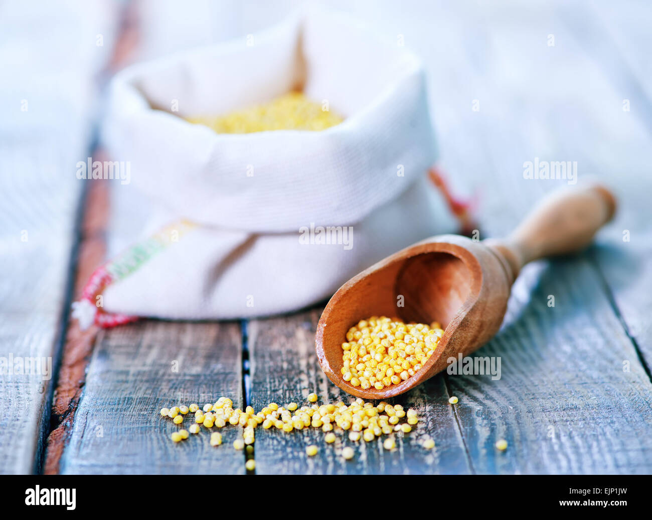 raw millet in wooden spoon and on a table Stock Photo - Alamy