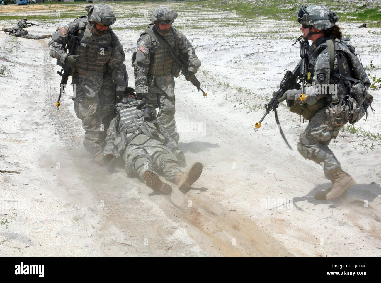 U.S. Army Soldiers drag Staff Sgt. Kevin Hartman out of harms way ...