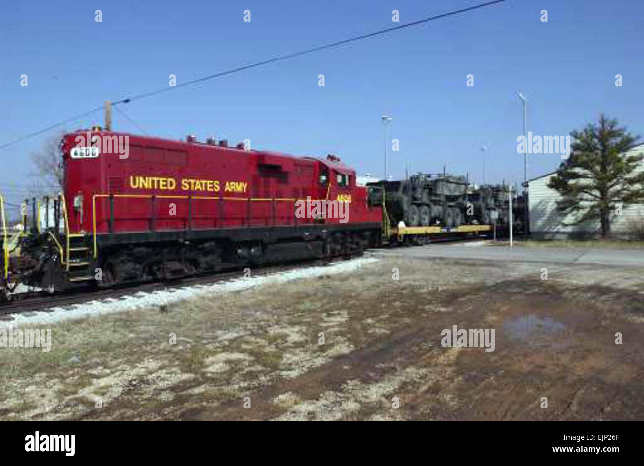 A U.S. Army locomotive moves loaded rail cars carrying equipment from ...