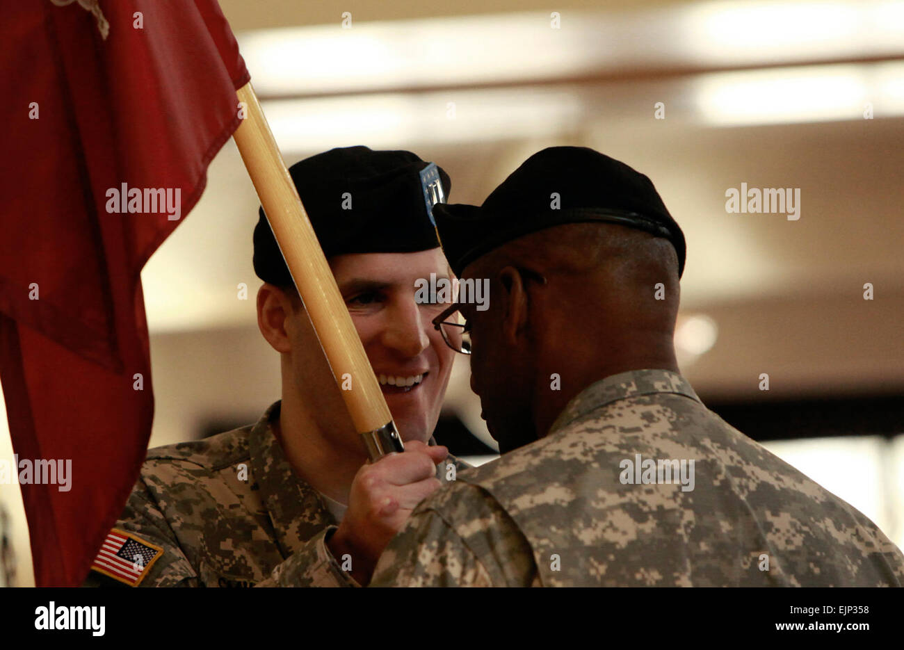 Capt. Scott M. Smiley grins while passing the guidon back to 1st Sgt ...