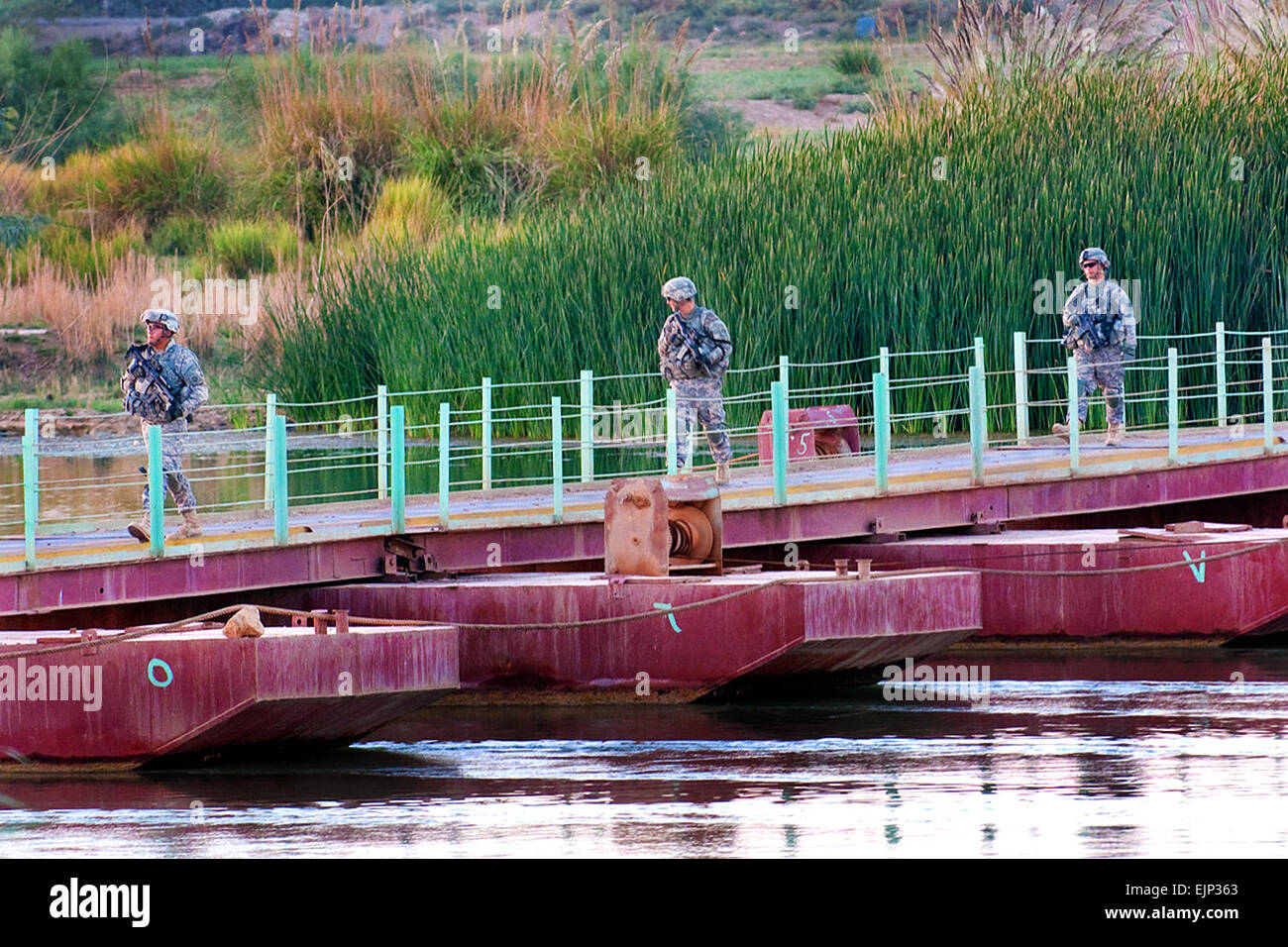 U.S. Army Soldiers return from a patrol across the Euphrates River ...