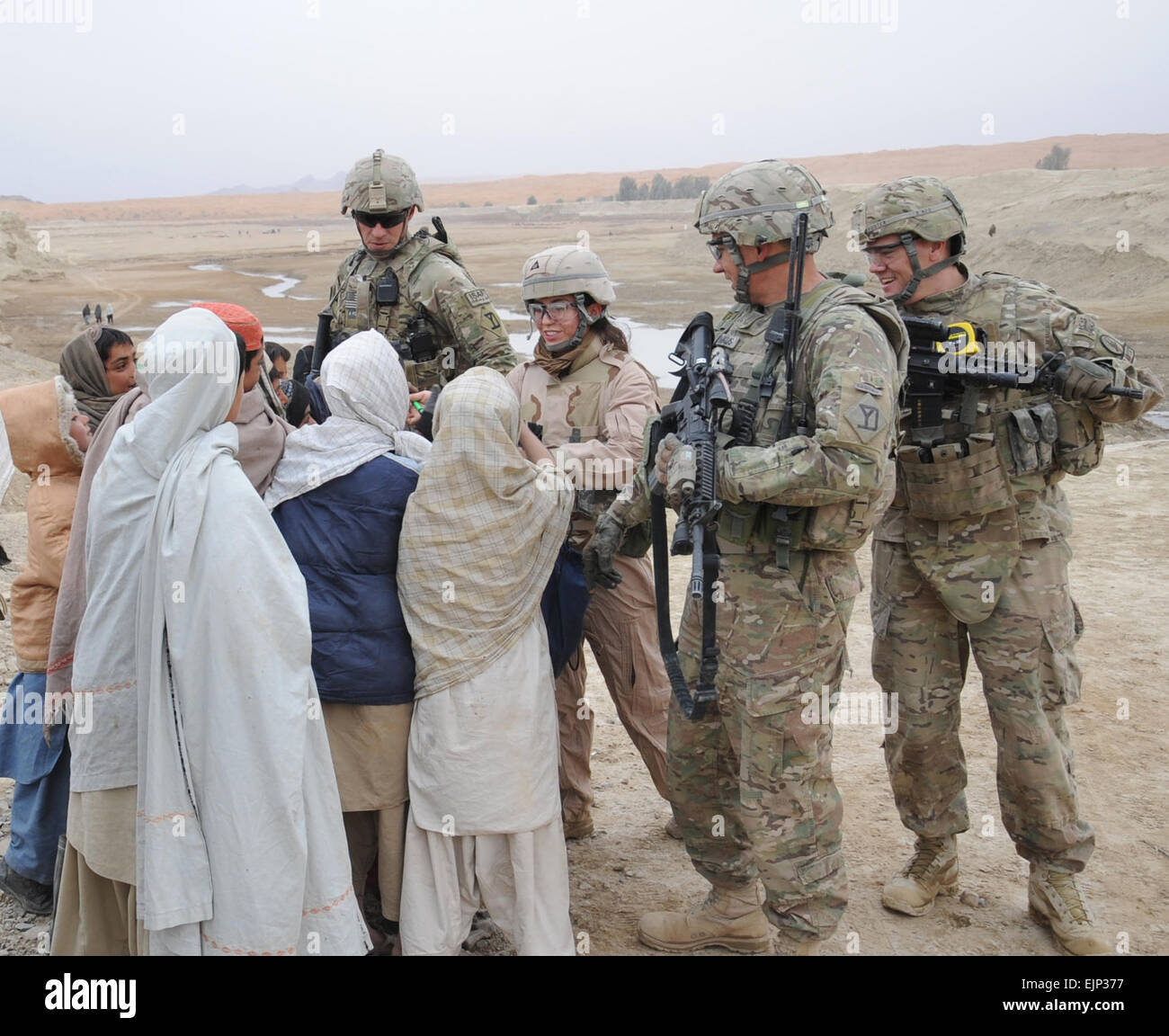 Members of Kandahar Provincial Reconstruction Team hand out pens to ...