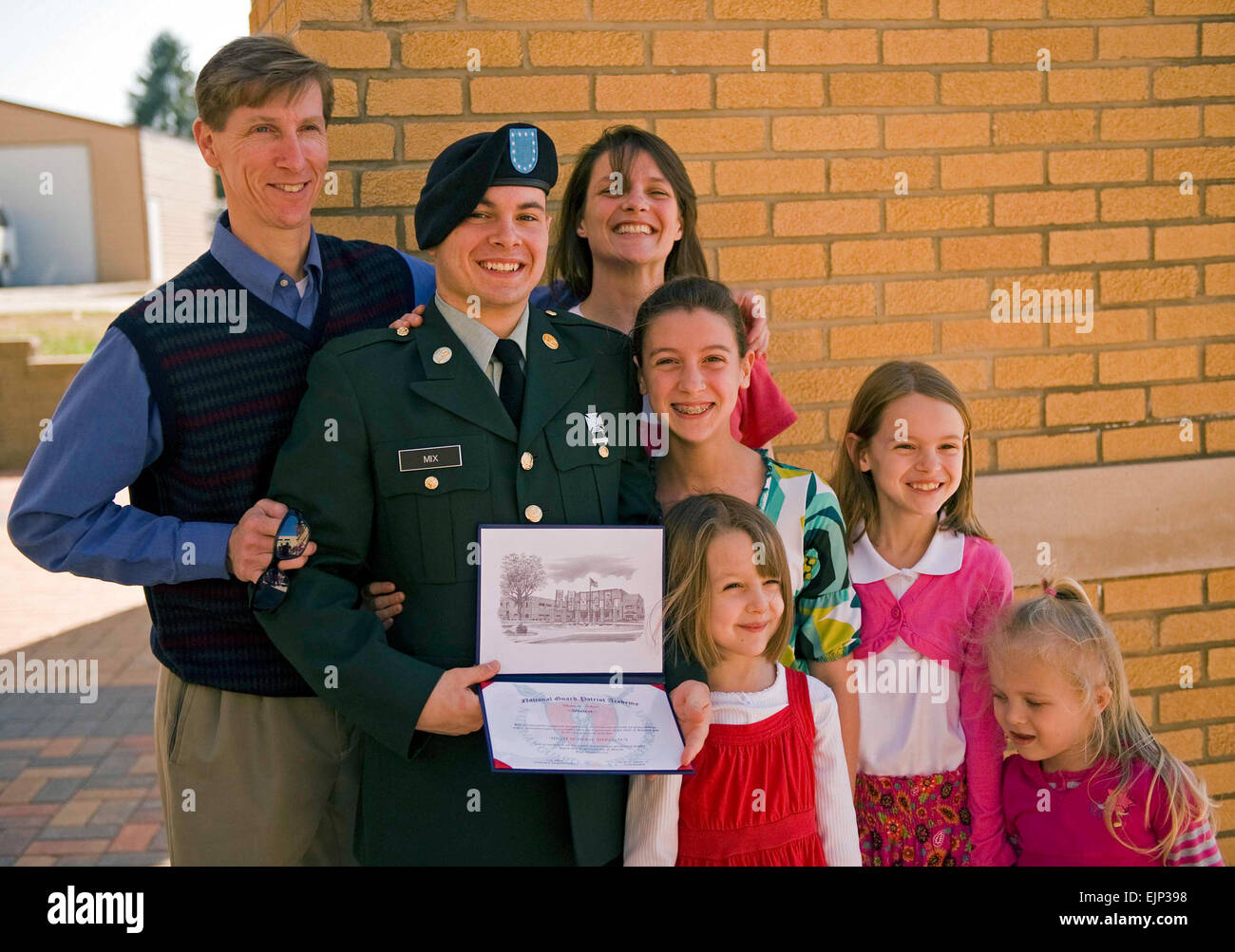 Pfc. Scott Mix proudly holds his newly earned high school diploma with ...