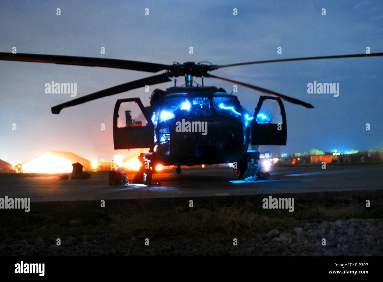 A prolonged exposure shows streaks of light from the headlamps of a ...