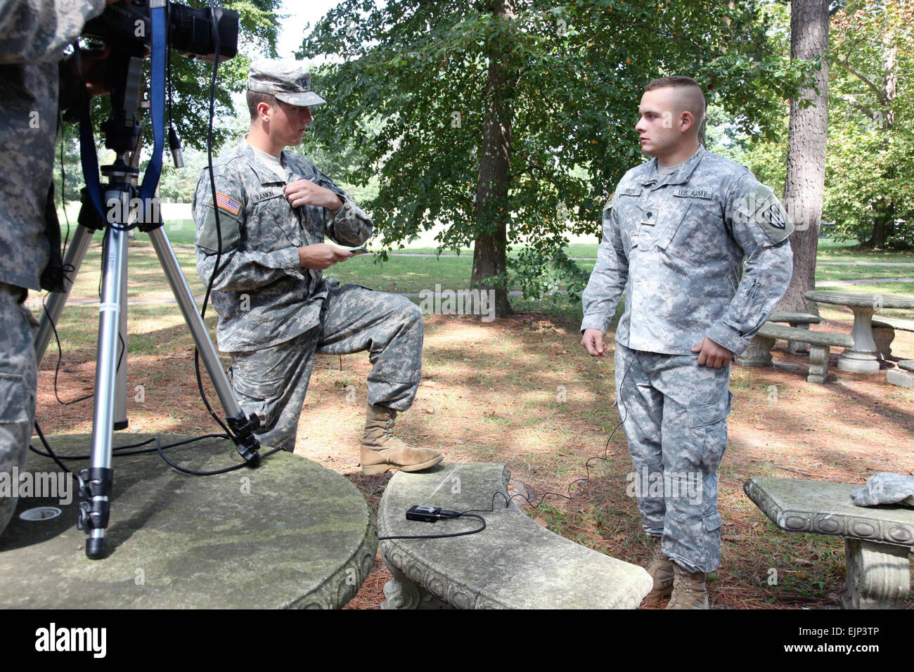 Spc. Bryan Rankin, 55th Combat Camera, helps Spc. Daniel Micek, U.S ...