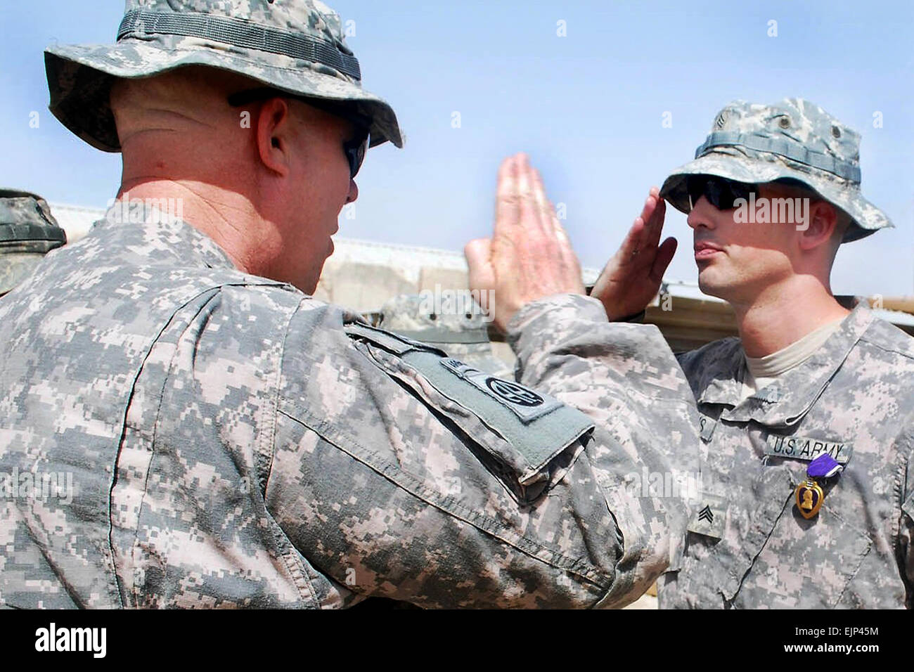 U.S. Army Col. Timothy McGuire, left, salutes Sgt. Ryan Higgins after ...