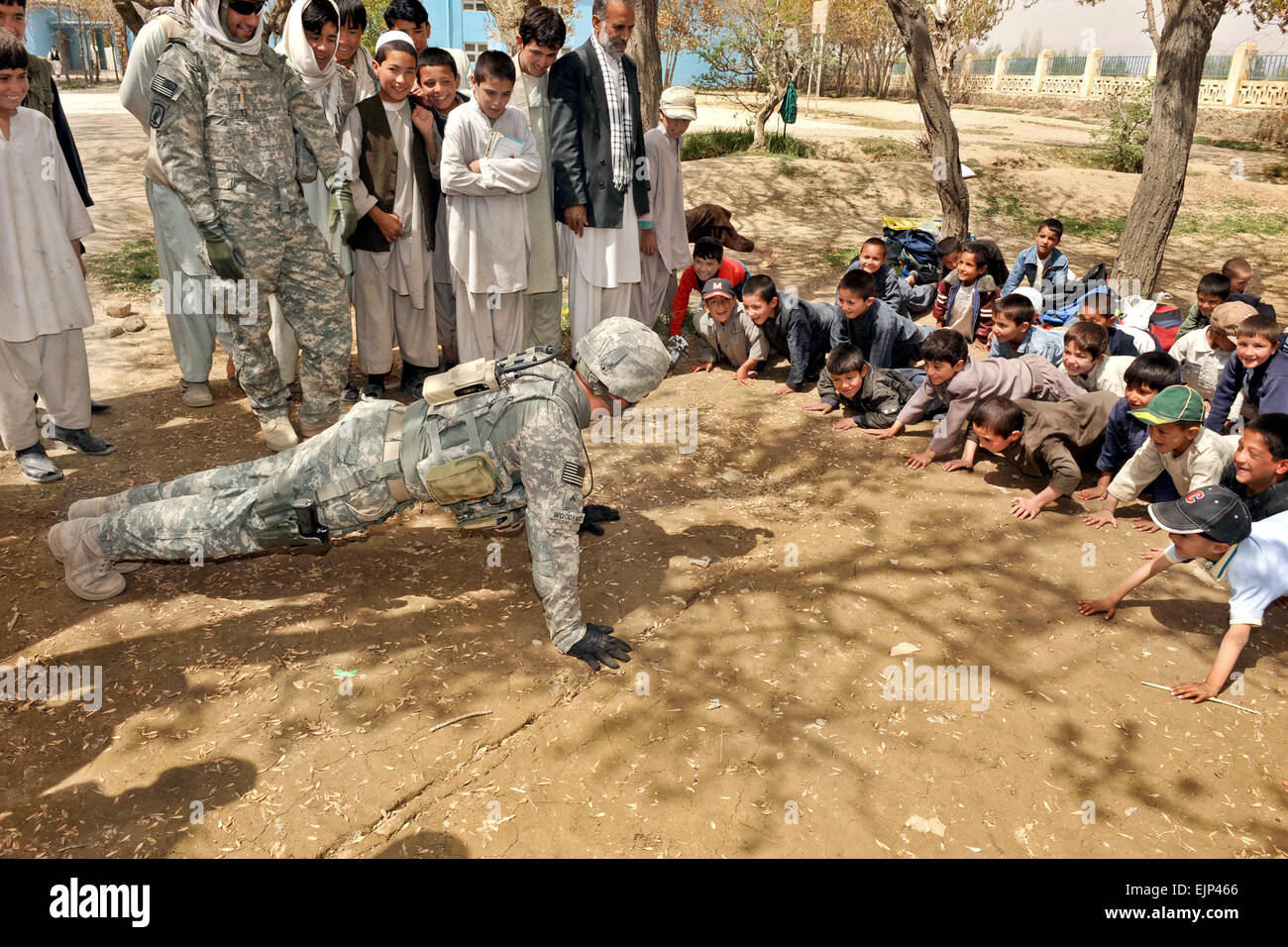 U.S. Army Cpl. Mark Woodyard teaches Afghan kids how to do push-ups at ...