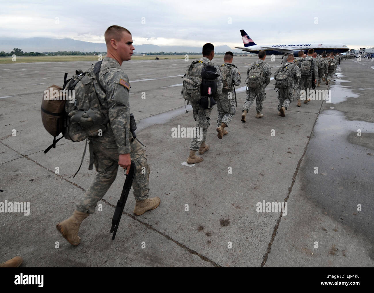 Soldiers assigned to the 82nd Airborne Division board a plane to return ...