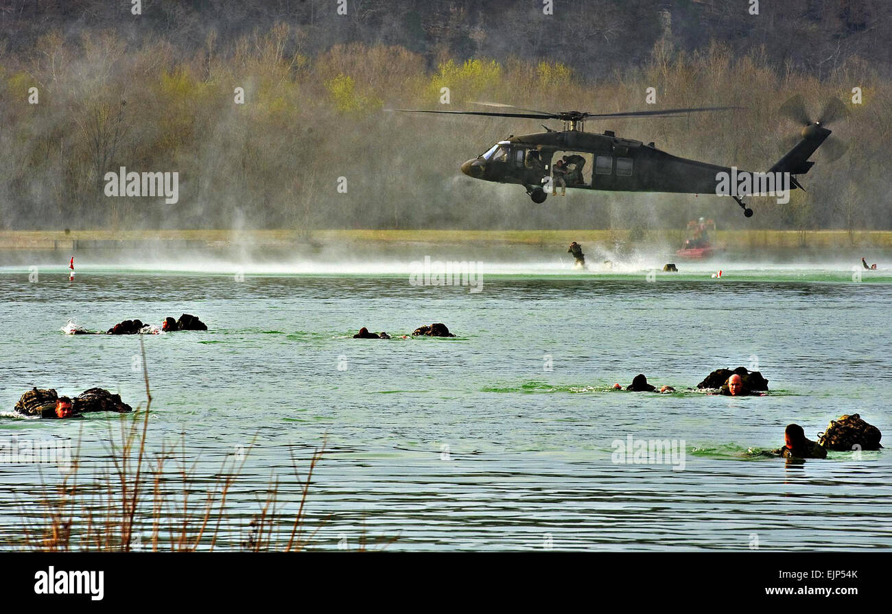Sappers jump from a hovering Blackhawk helicopter and swim across a ...