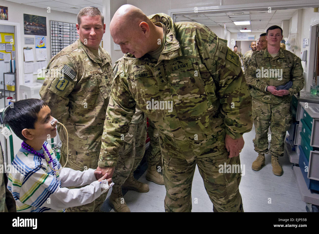 U.S. Army Chief of Staff Gen. Ray Odierno shakes the hand of an Afghan ...