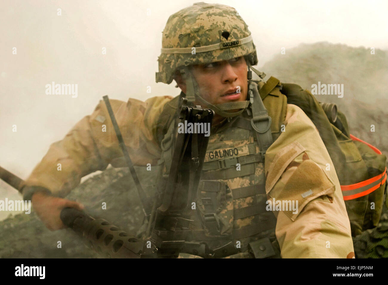 U.S. Army Spc. Andres Galindo adjusts the barrel of a .50 caliber ...