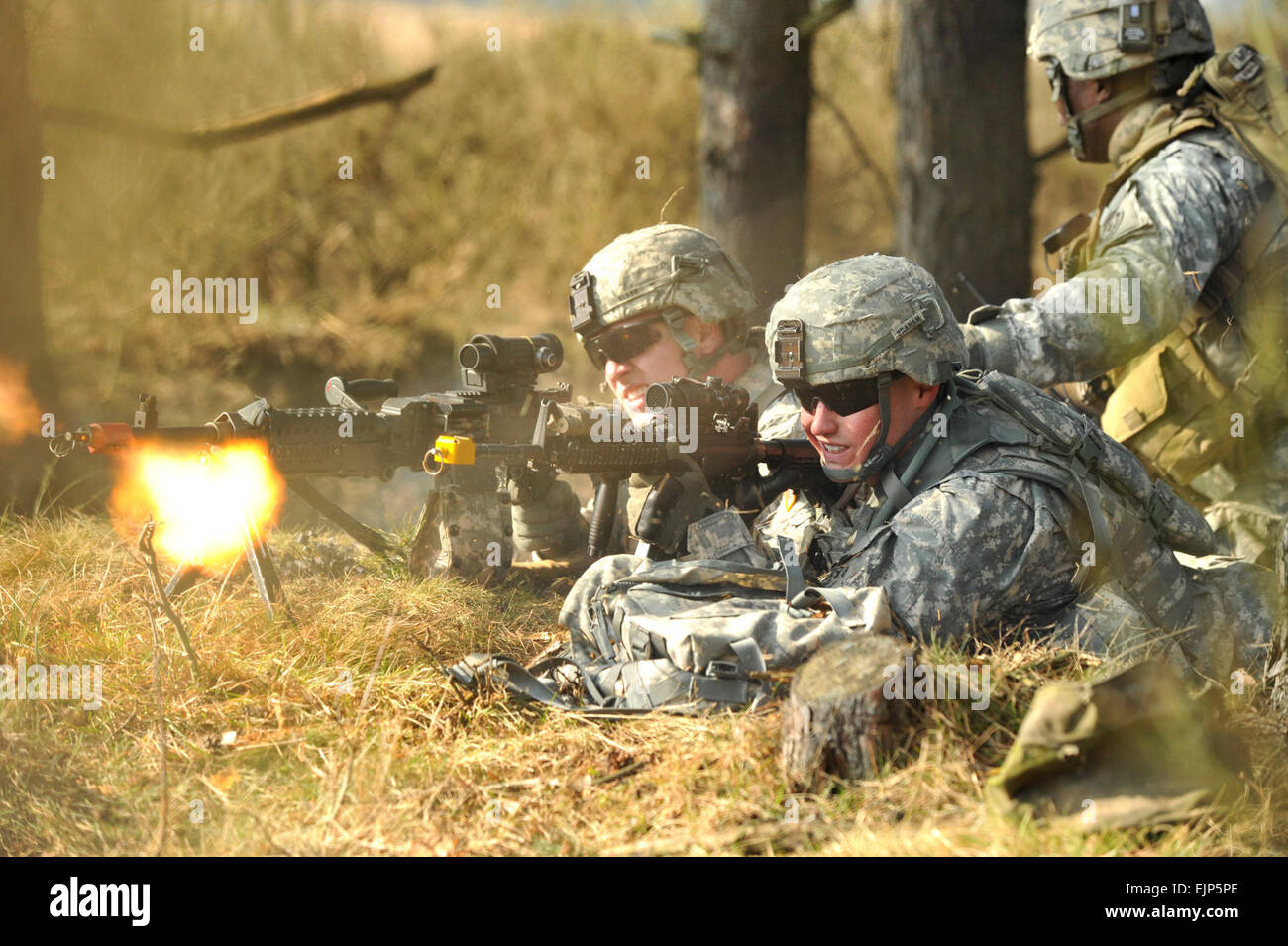 U.S. Army Pvt. Ryan Slade left fires an M240 machine gun as Spc. Cody ...