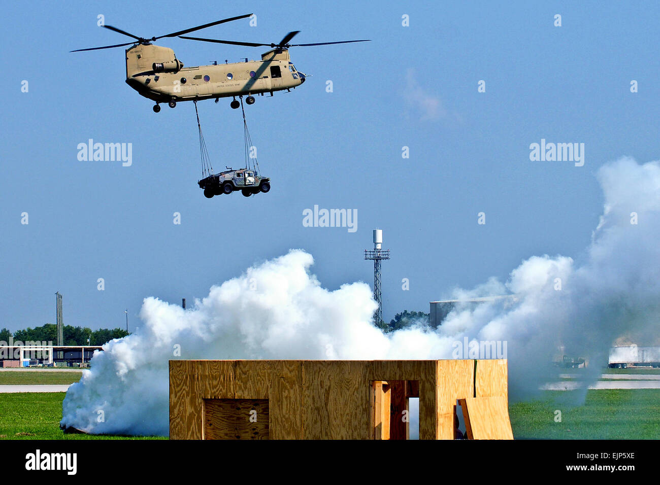 Two Humvees dangle below a CH-47 Chinook during a sling load ...