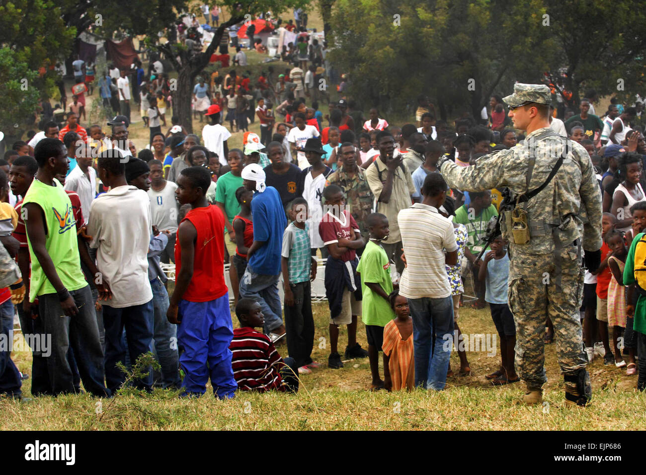 A crowd gathers at a country club that U.S. Soldiers are using as a ...
