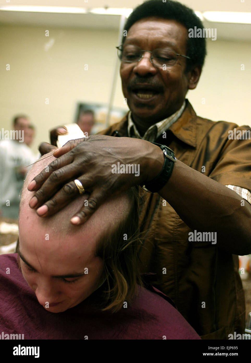 U.S. Army Pvt. Jesse Carroll receives his initial haircut during basic ...