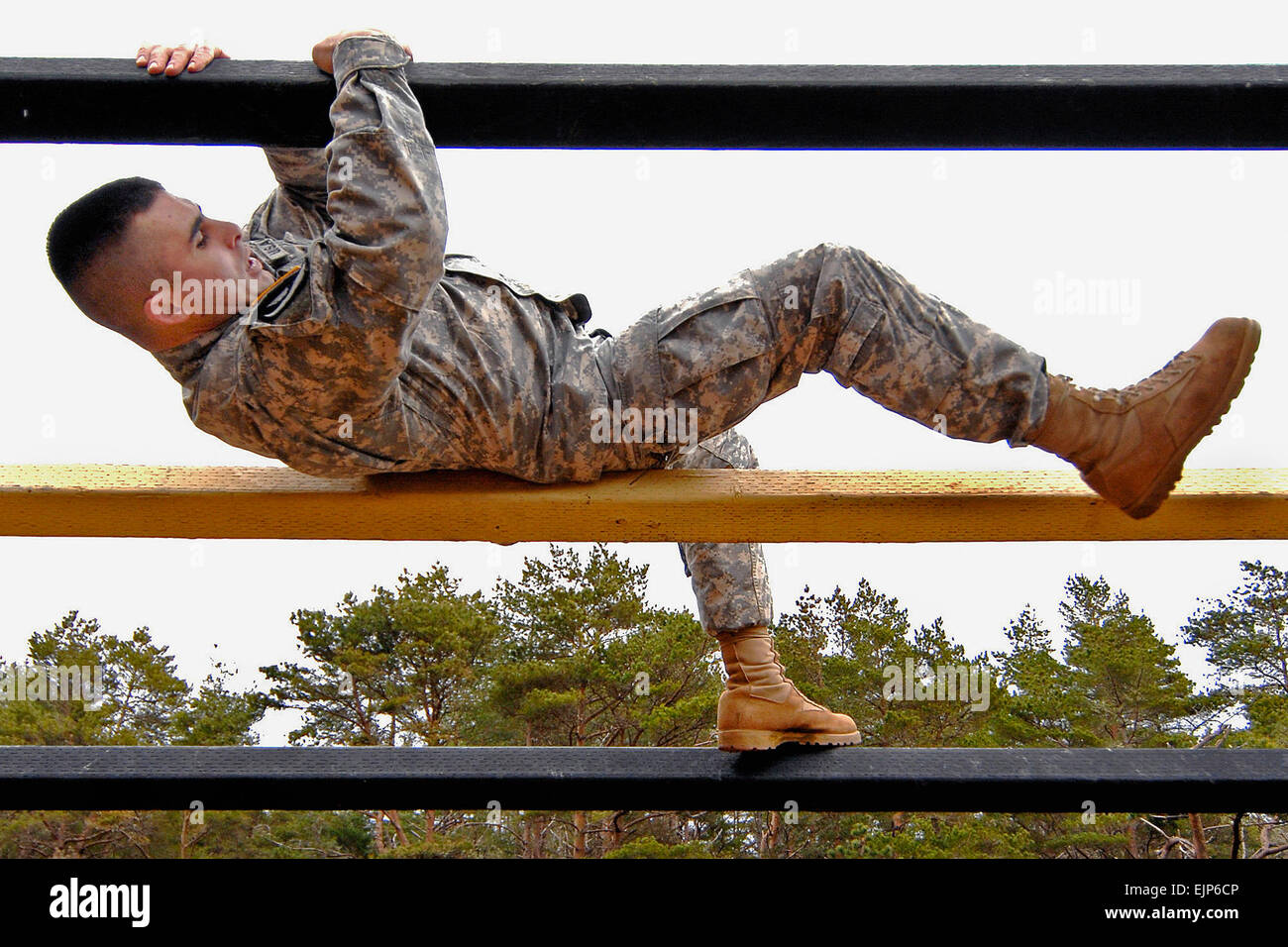Staff Sgt. Jesse Ginestar negotiates the 'weaver' obstacle during the ...