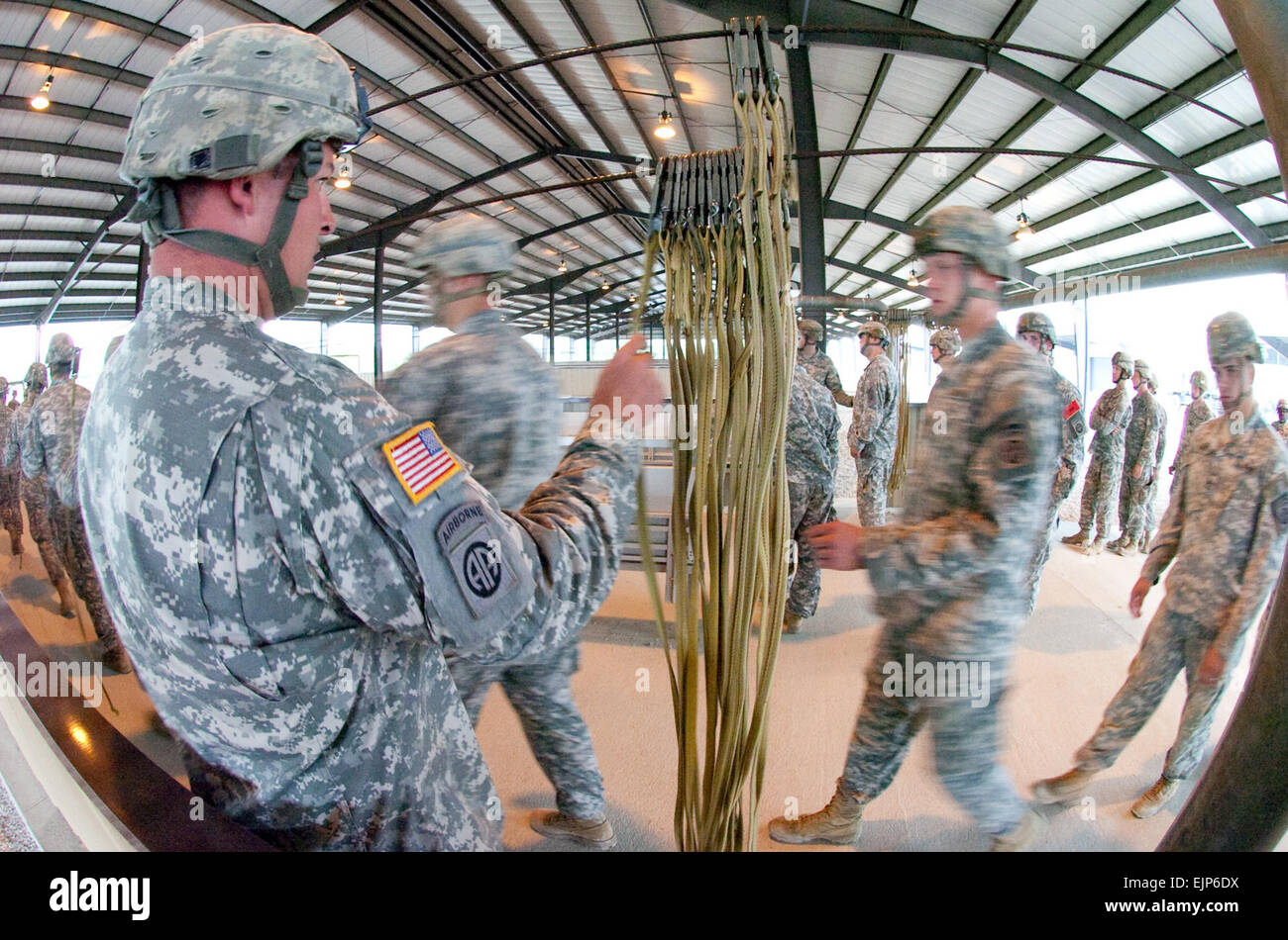 A jumpmaster with 1st Brigade Combat Team, 82d Airborne Division, hands ...