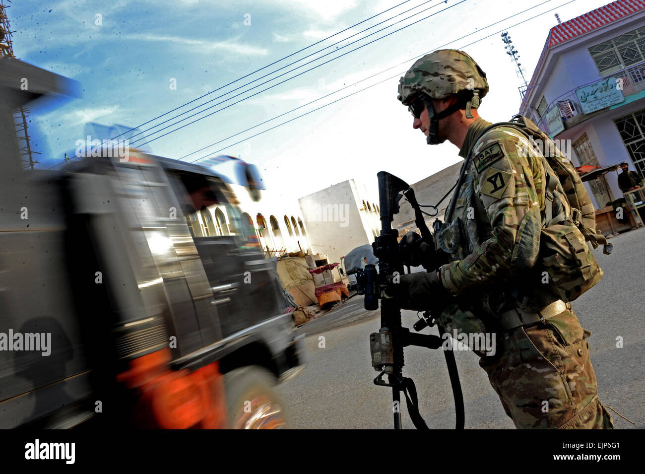 U.S. Army Spc. Kevin Medeiros, rifleman, secures an area in Qalat City ...
