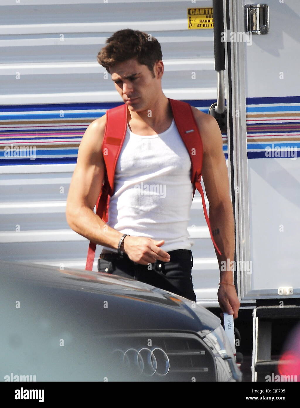 Actor Zac Efron shows off his biceps while on the set of his new movie ...