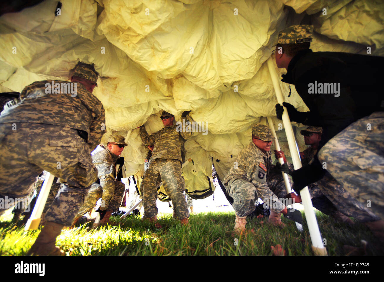 U.S. Army Soldiers erect a command and control tent at a forward ...