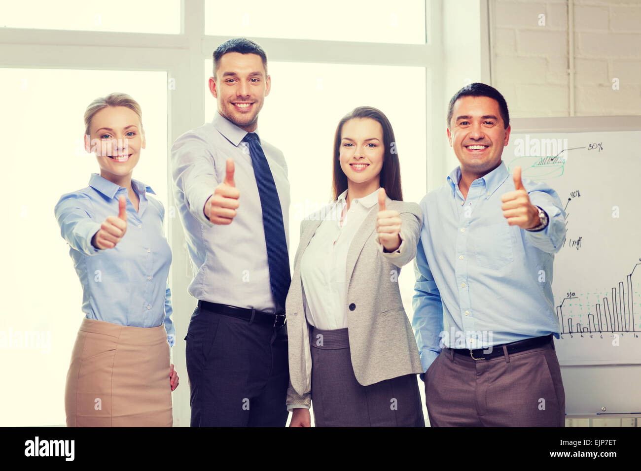 business team showing thumbs up in office Stock Photo - Alamy