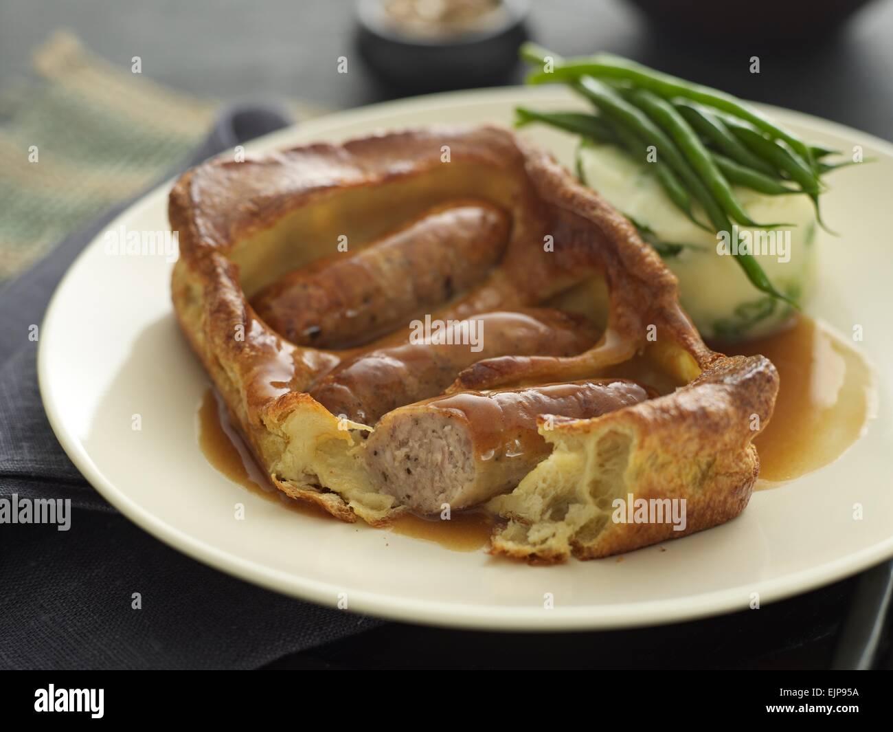 plated meal of toad in the hole Yorkshire pudding and Sausages with ...