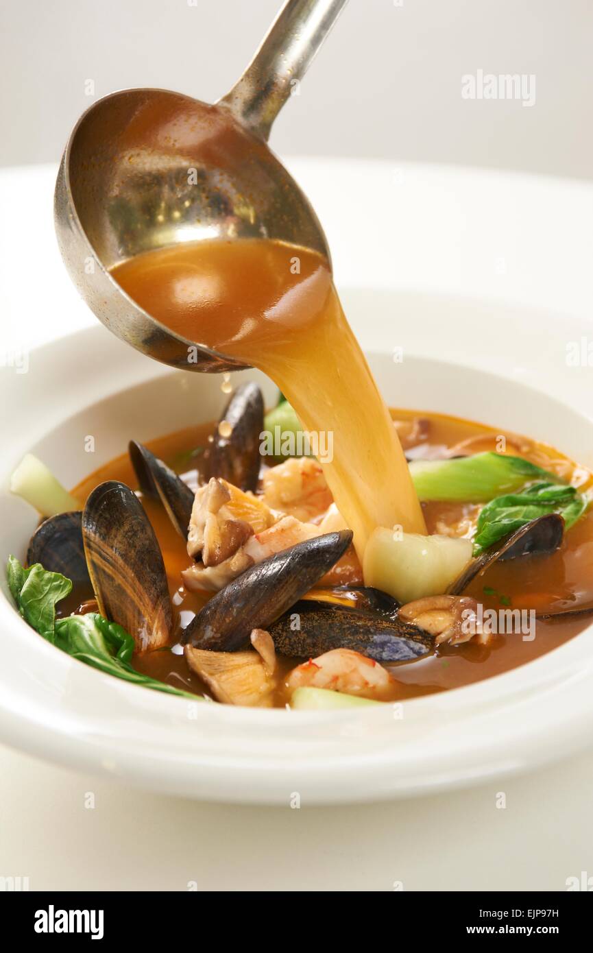 meal ladle and bowl of fruit de mer fish soup Stock Photo - Alamy