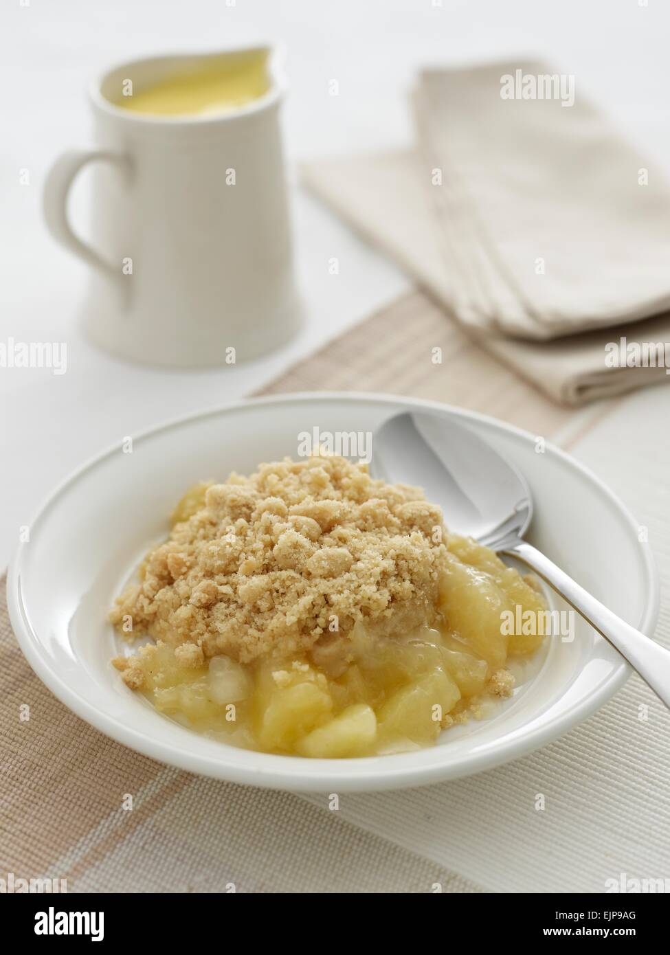 Bowl of Apple crumble and custard Stock Photo - Alamy