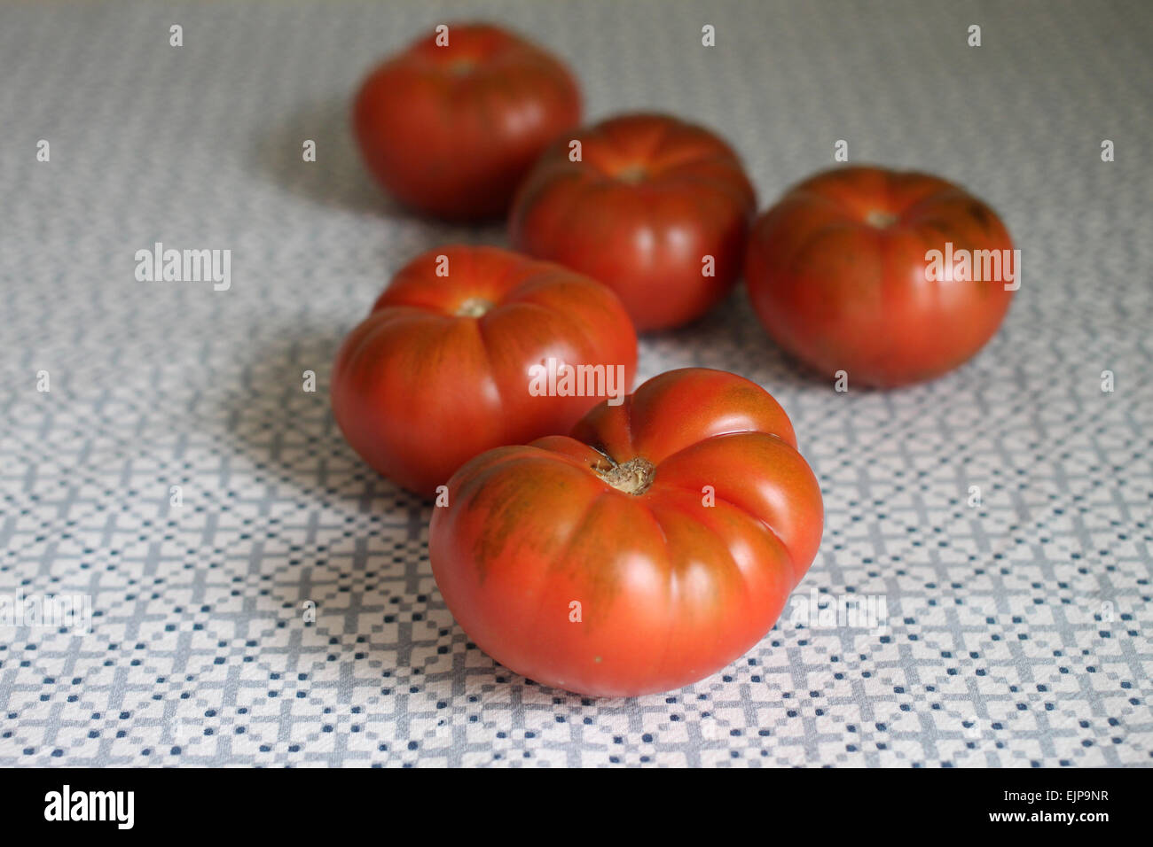Raf tomatoes (Solanum lycopersicum) on table cloth Stock Photo - Alamy