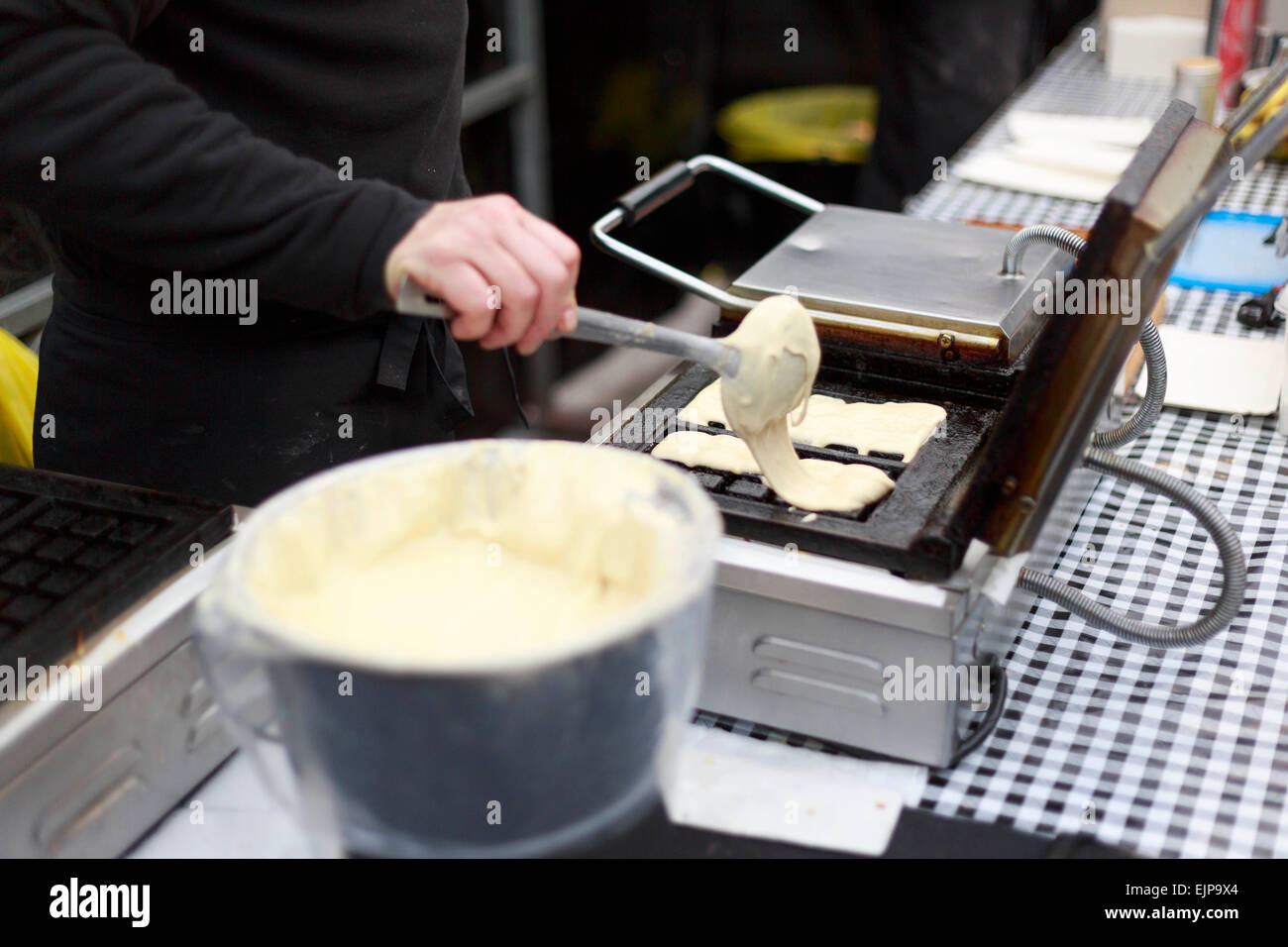 A man makes Waffles chocolate in the street market. Amsterdam is one of ...