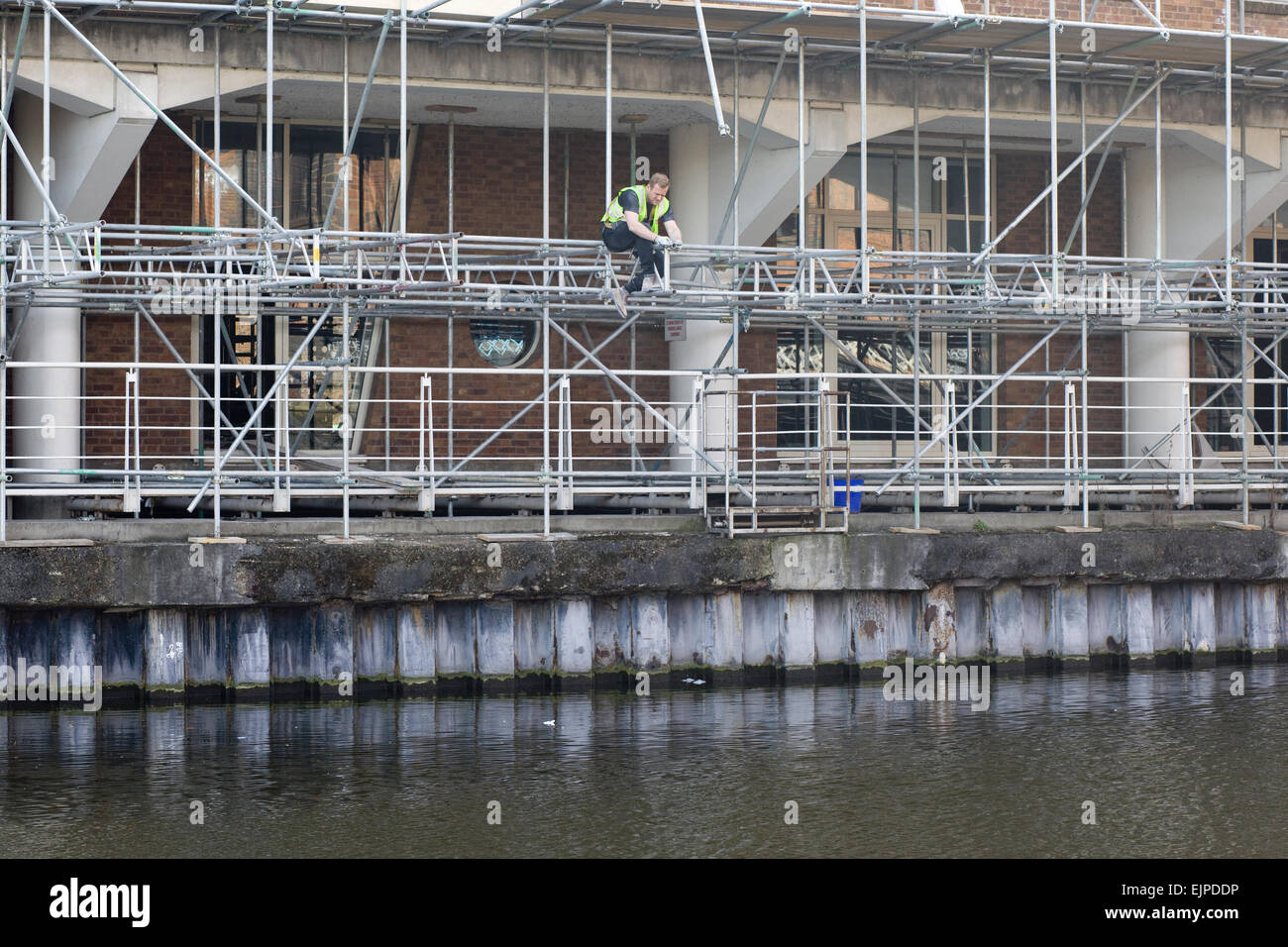 Men working on a building supported by Scaffolding Stock Photo - Alamy