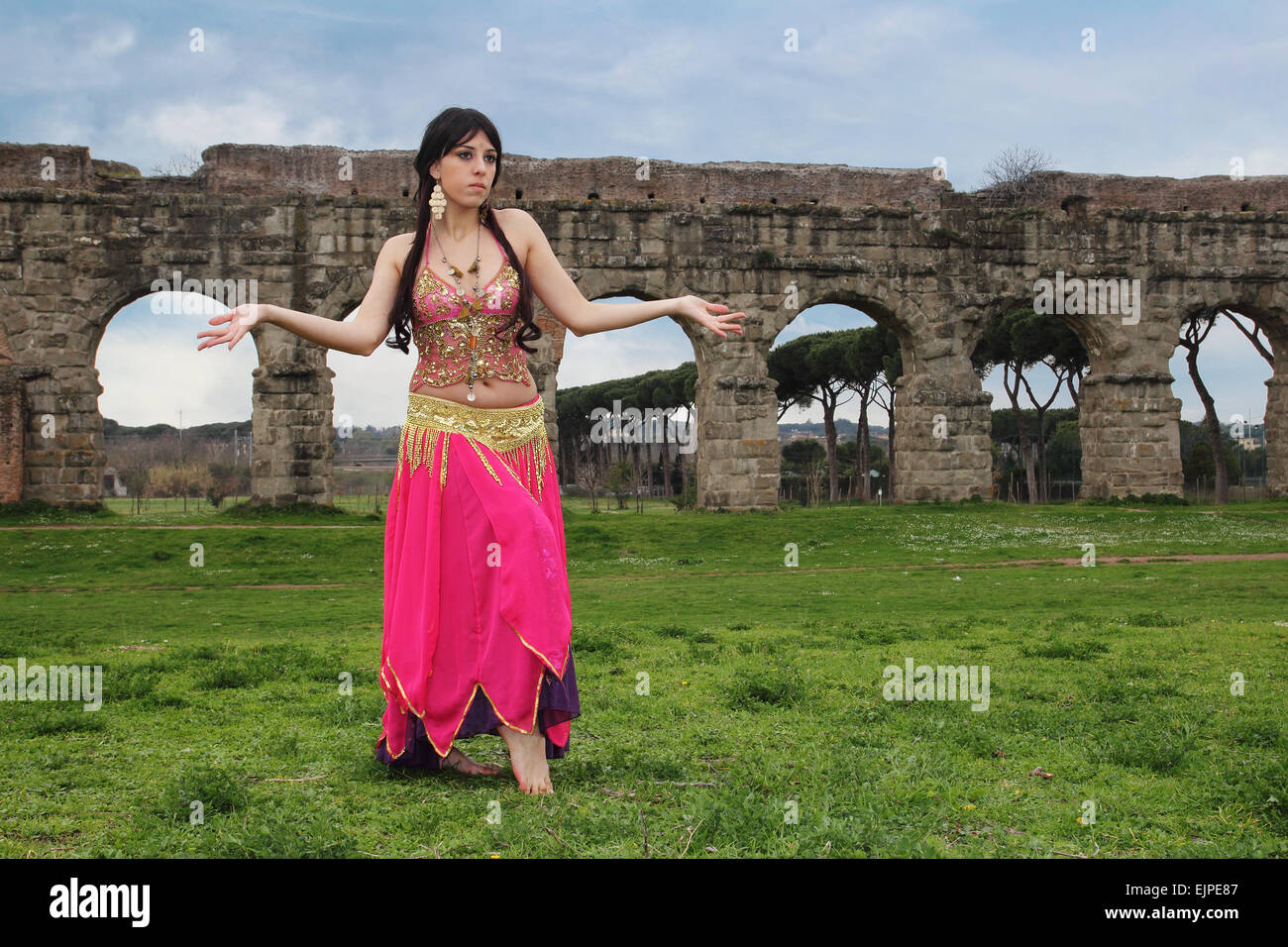 belly dancer with ancient Roman aqueducts ruins in the background Stock ...