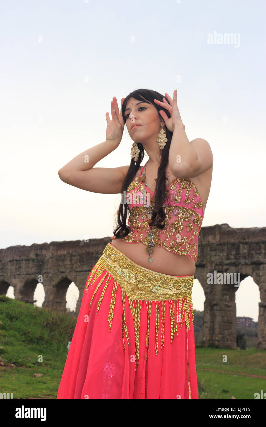 belly dancer with ancient Roman aqueducts ruins in the background Stock ...