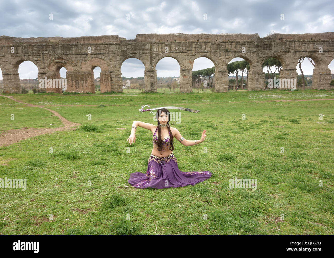 belly dancer with sword under the ancient Roman aqueduct Stock Photo ...
