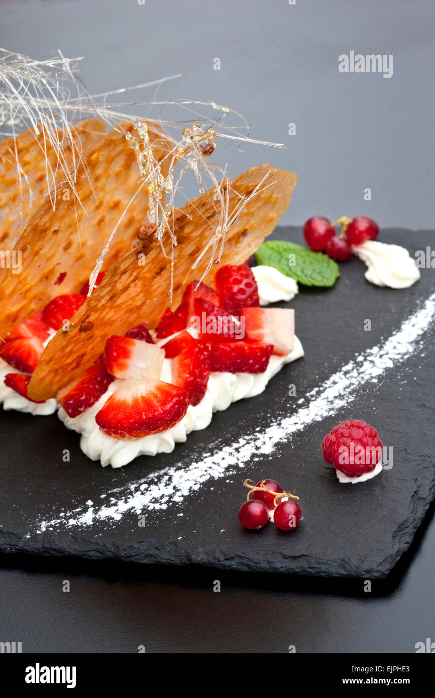 Biscuit, Chantilly cream and red fruits on a plate Stock Photo - Alamy