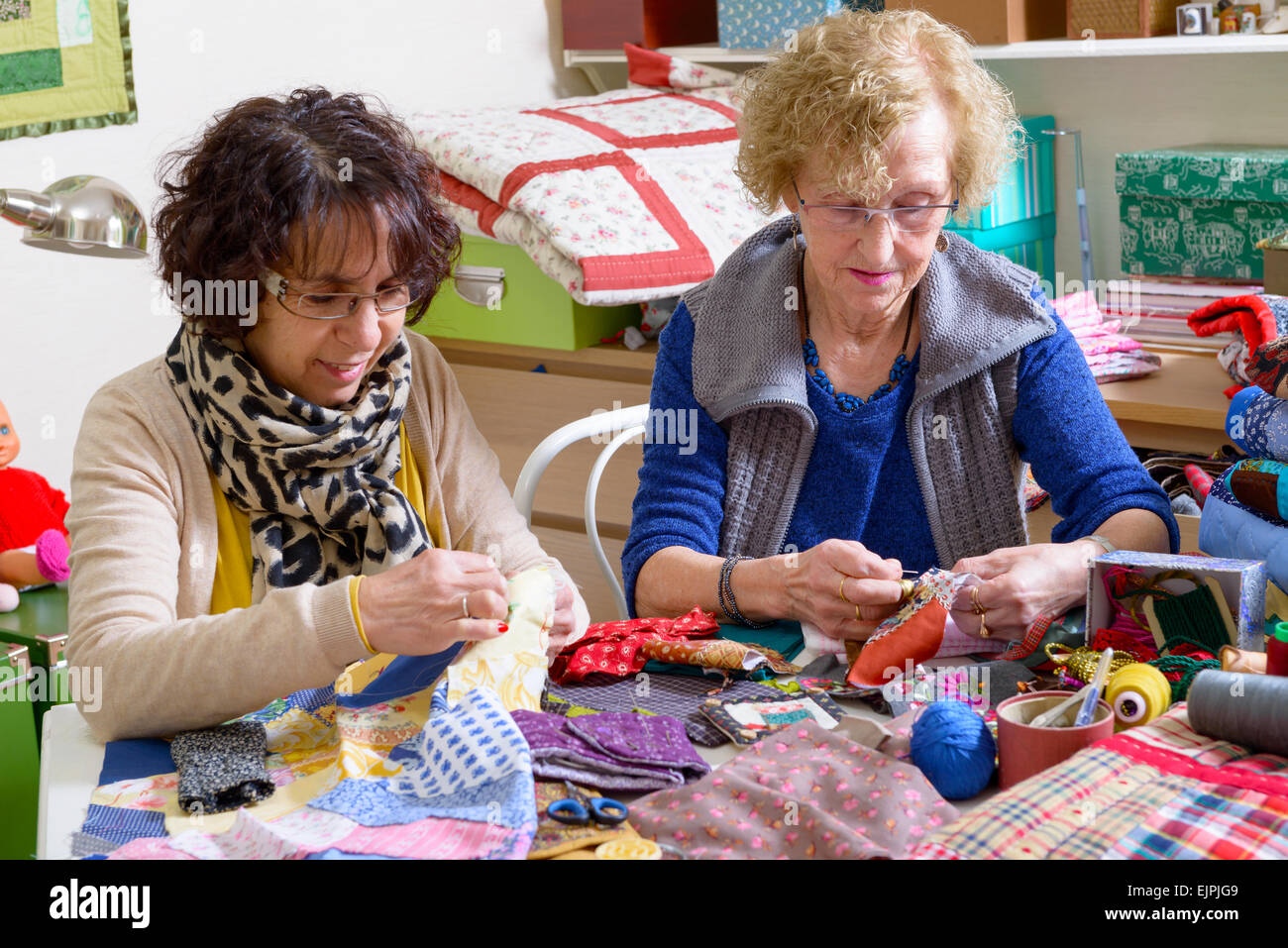 two women working on their patchwork in the workshop Stock Photo - Alamy