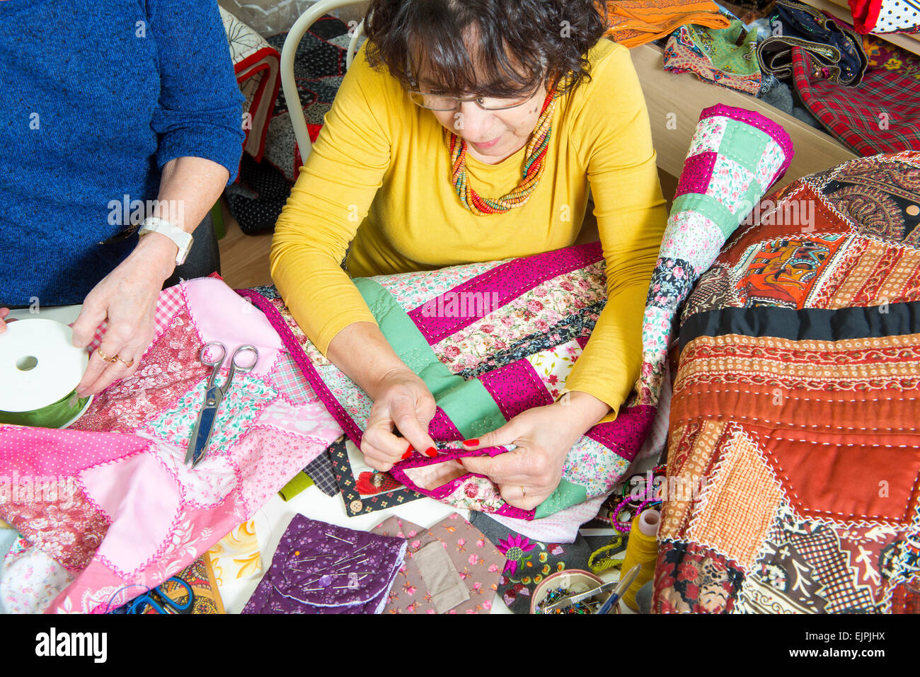 two women working on their patchwork in the workshop Stock Photo - Alamy