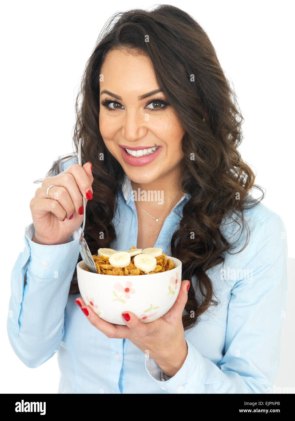 Attractive Young Woman Eating Breakfast Cereals with Banana Stock Photo - Alamy